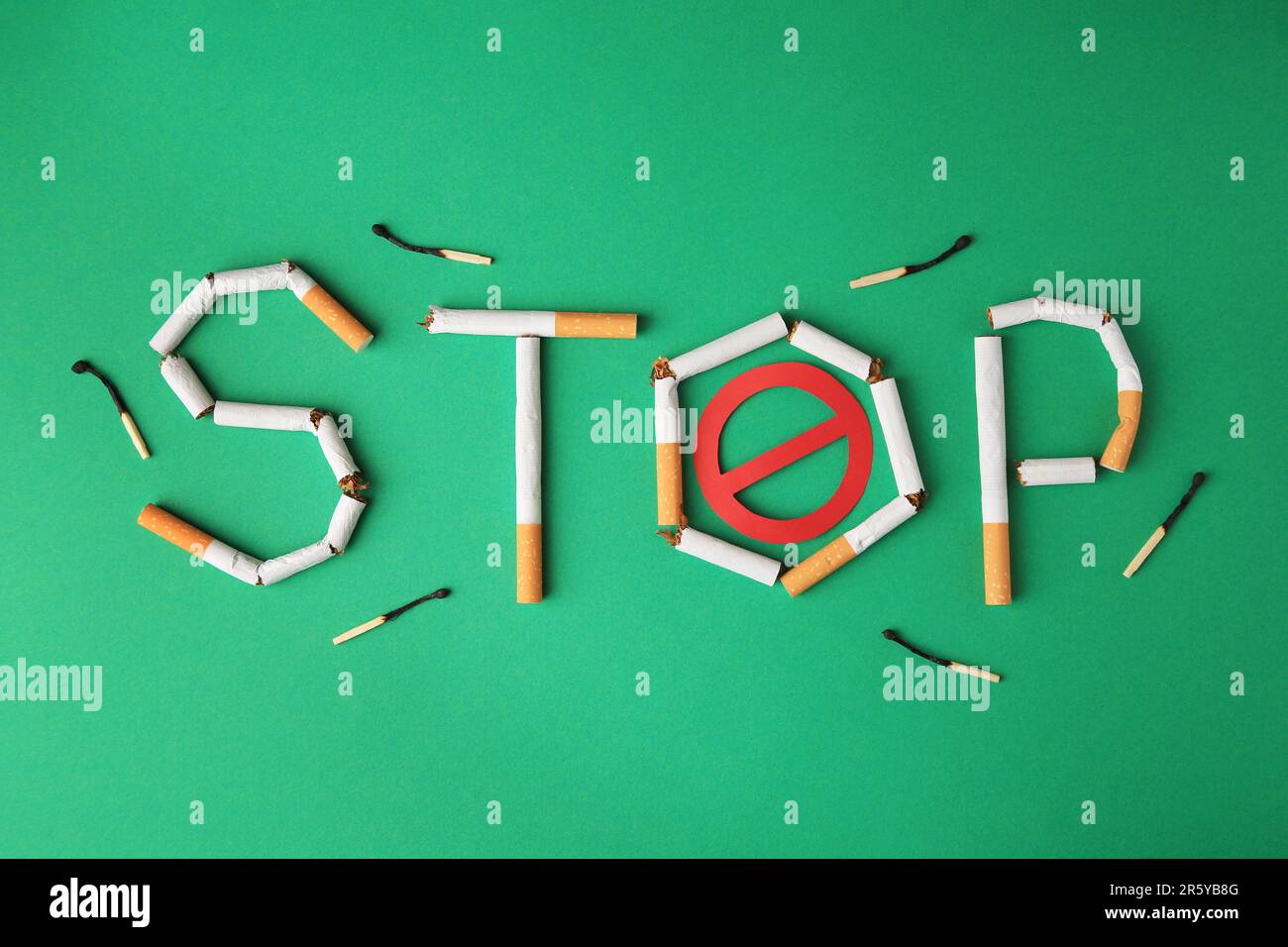 Word Stop made of broken cigarettes, prohibition sign and burnt matches ...