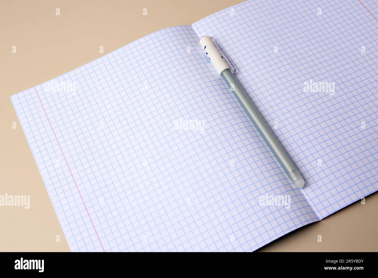 Copybook with erasable pen on beige background Stock Photo - Alamy