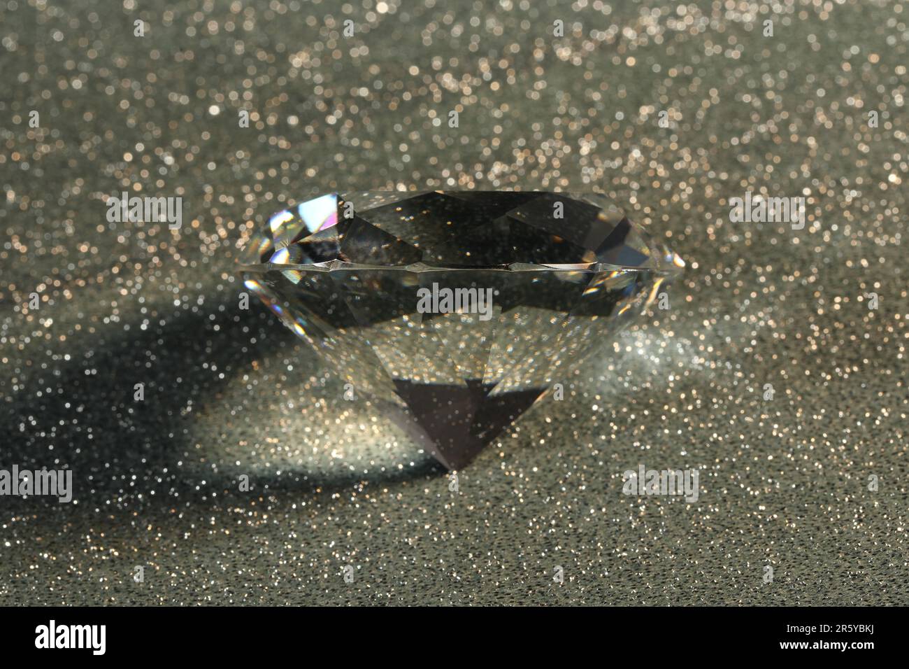 Beautiful dazzling diamond on glitter background, closeup Stock Photo ...