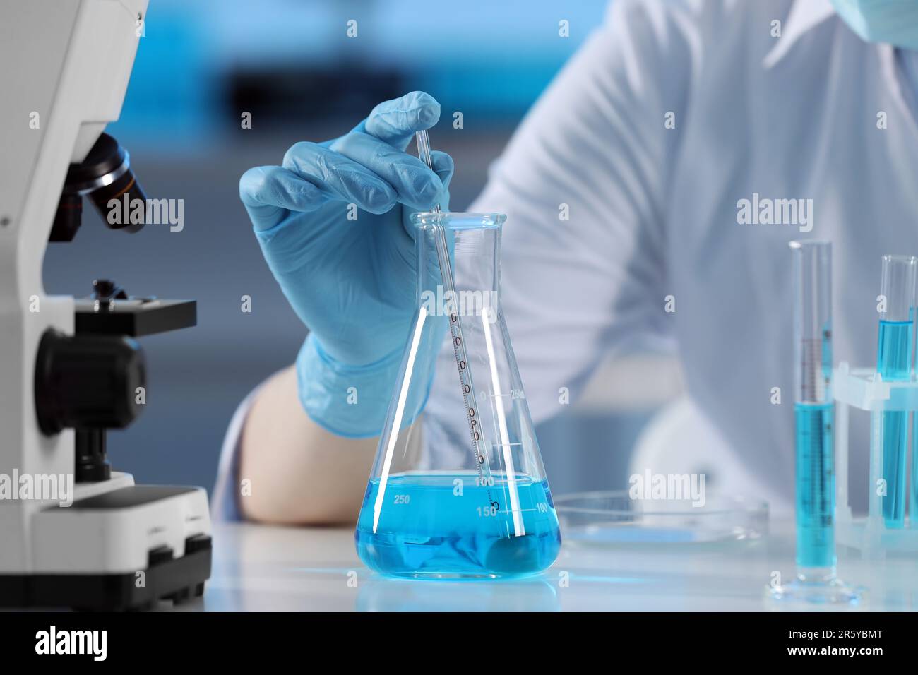 Scientist taking sample blue liquid hi-res stock photography and images ...