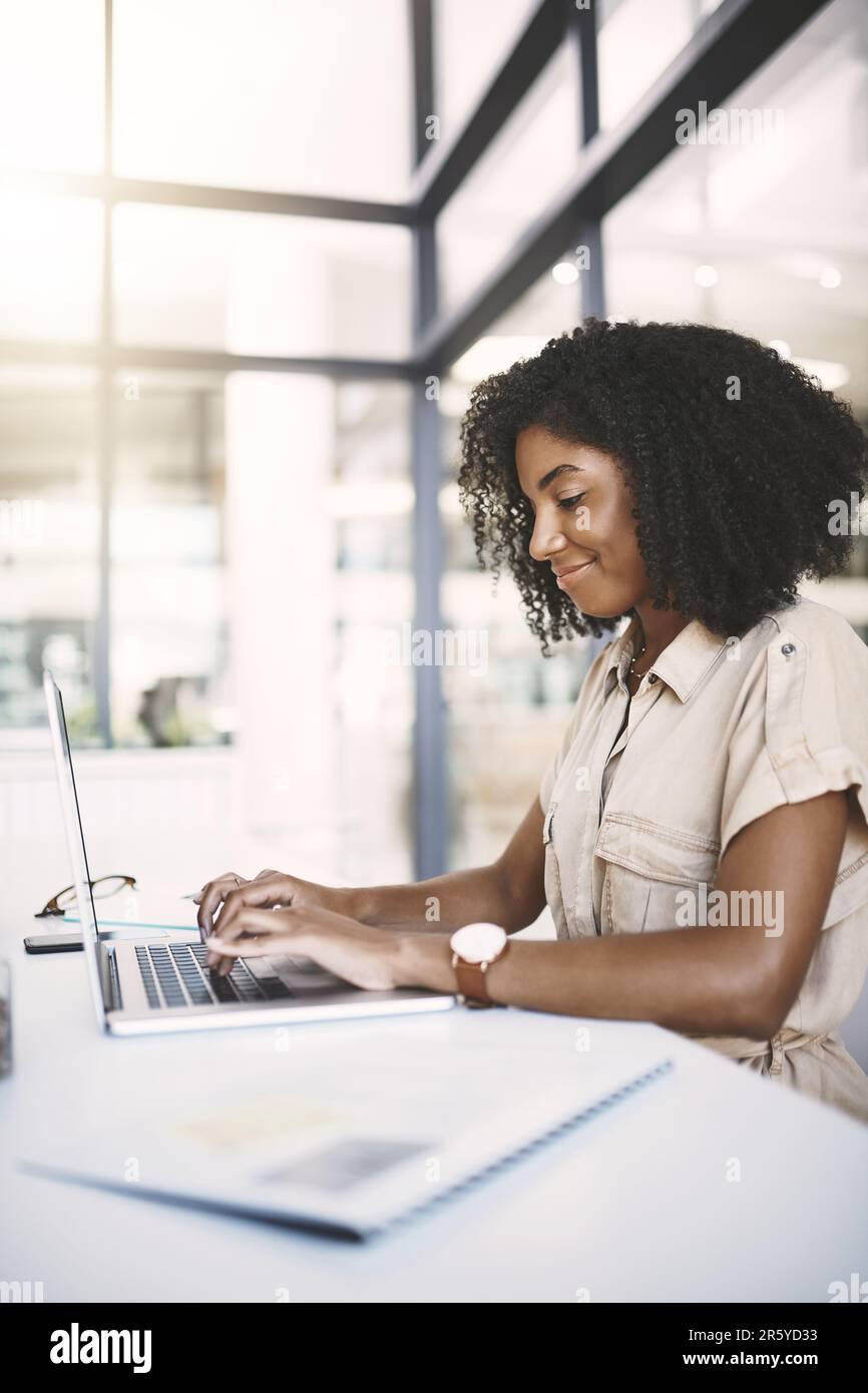 Hard work makes it happen. a young businesswoman using a laptop at her ...