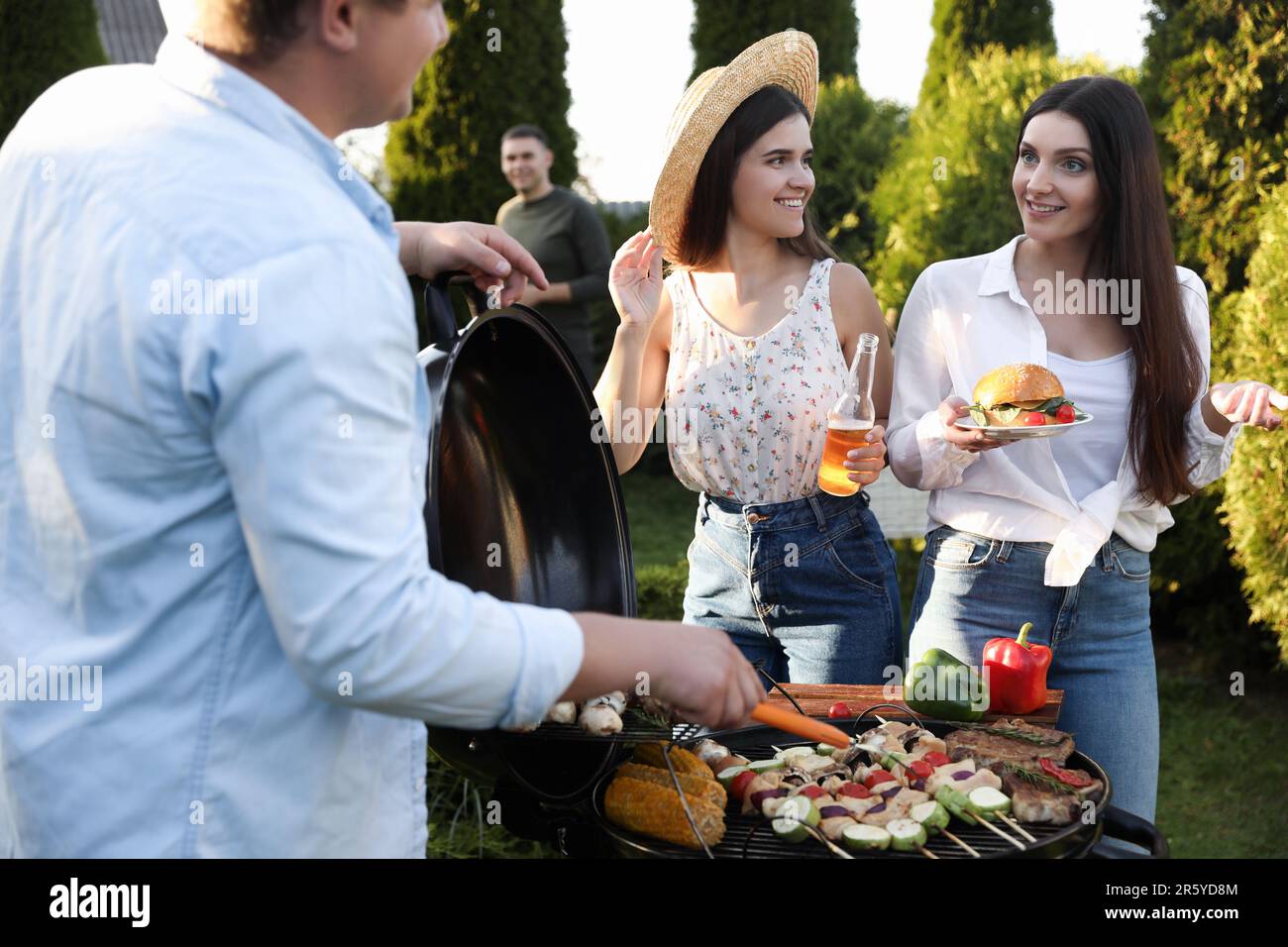 Group of friends having barbecue party outdoors Stock Photo - Alamy