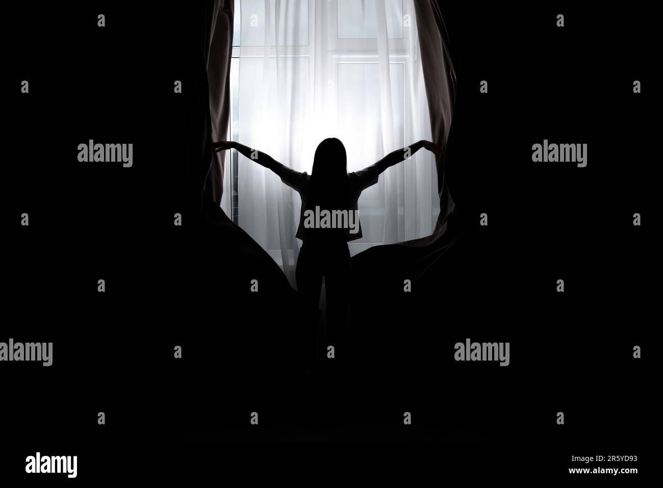 Silhouette of woman opening curtains at home, back view Stock Photo - Alamy