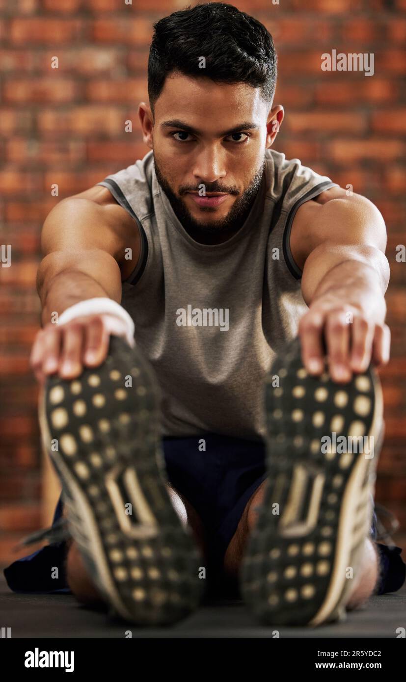 Gym, portrait of man stretching legs and warm up, workout motivation ...