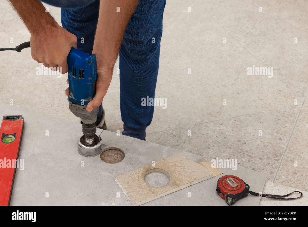 Worker making socket hole in tile indoors, closeup Stock Photo - Alamy