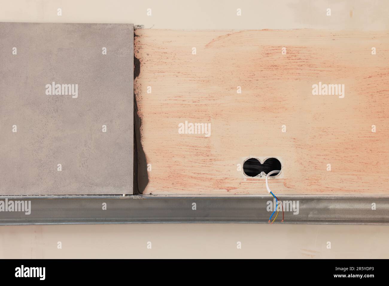 Holes for sockets with cables on wall. Tiles installation process Stock ...