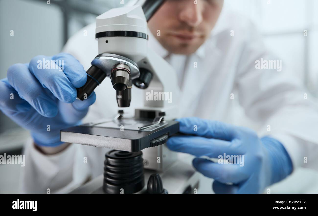 biologist explores the substance under the microscope Stock Photo - Alamy