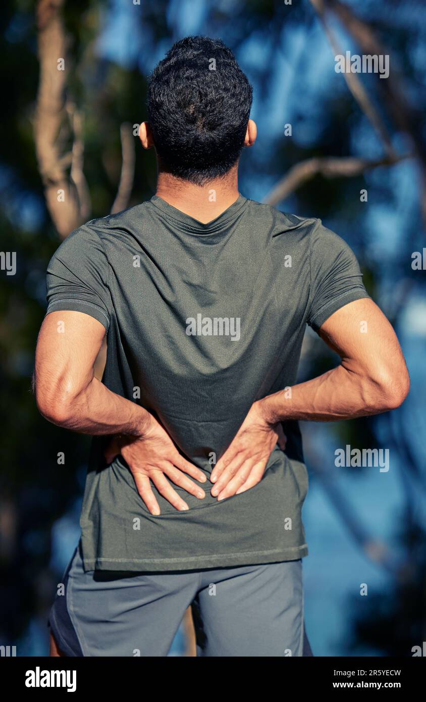 Man, back pain and fitness injury outdoor after accident, exercise or ...