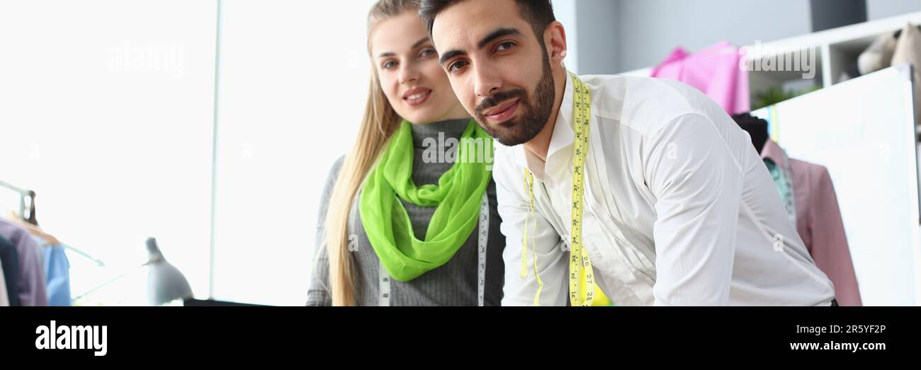 Two young stylists of the designer communicate in atelier Stock Photo ...