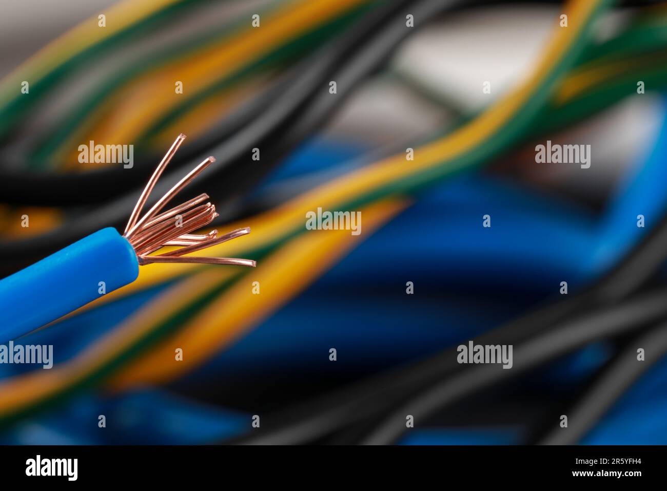 Light blue electrical wire on blurred background, closeup. Space for ...