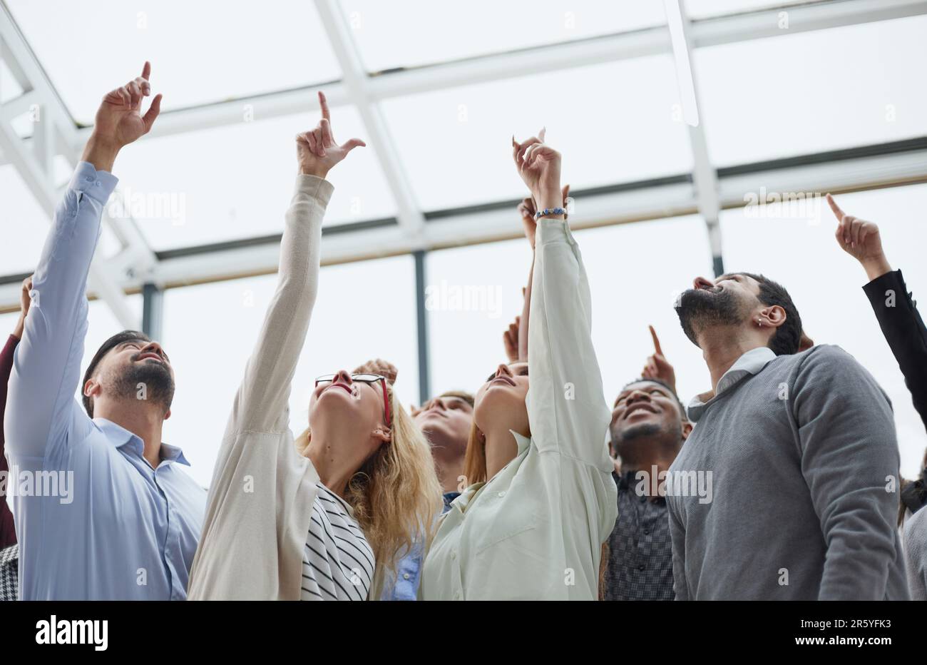 multi-ethnic men and women raise their hands Stock Photo - Alamy