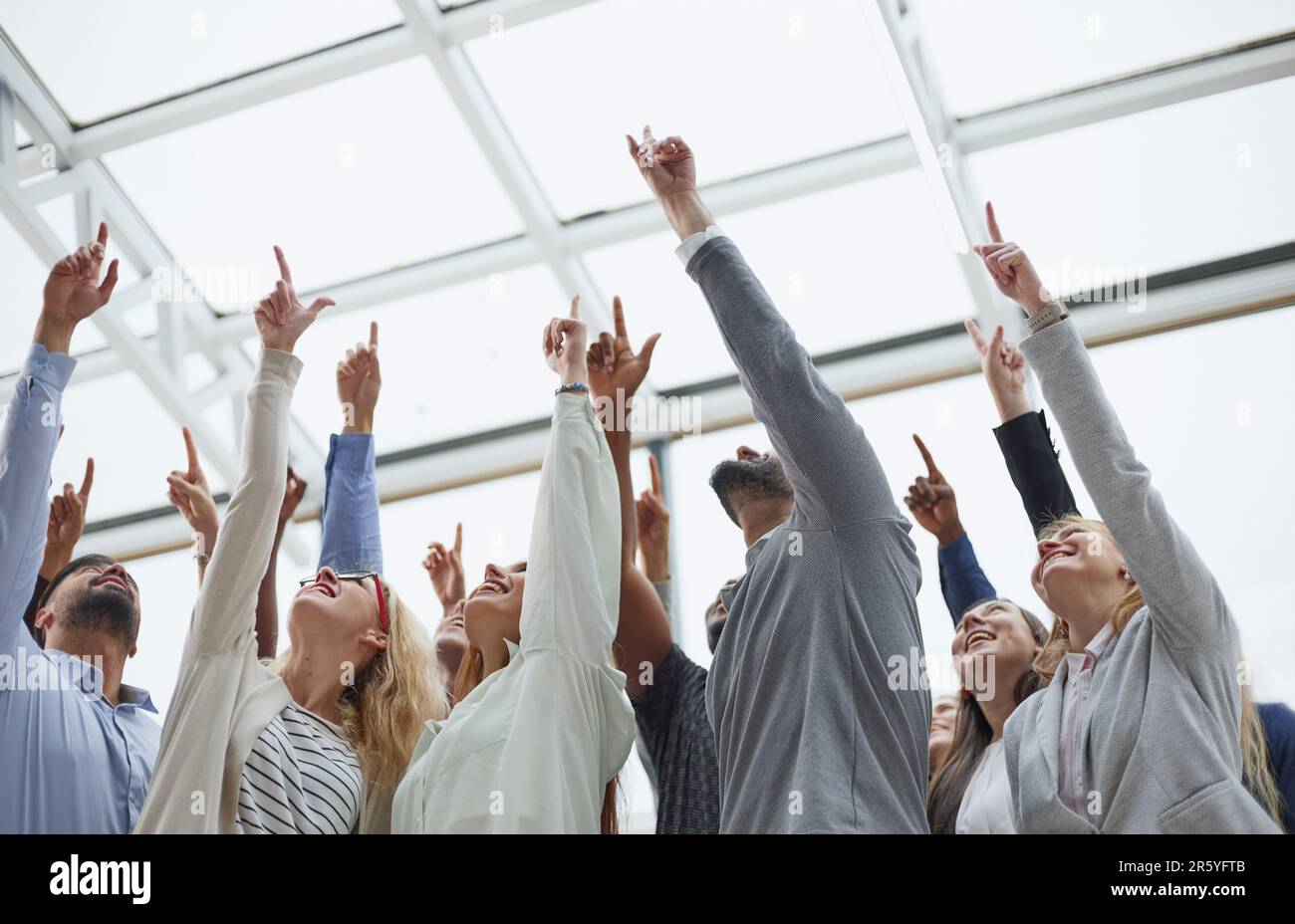 multi-ethnic men and women raise their hands Stock Photo - Alamy