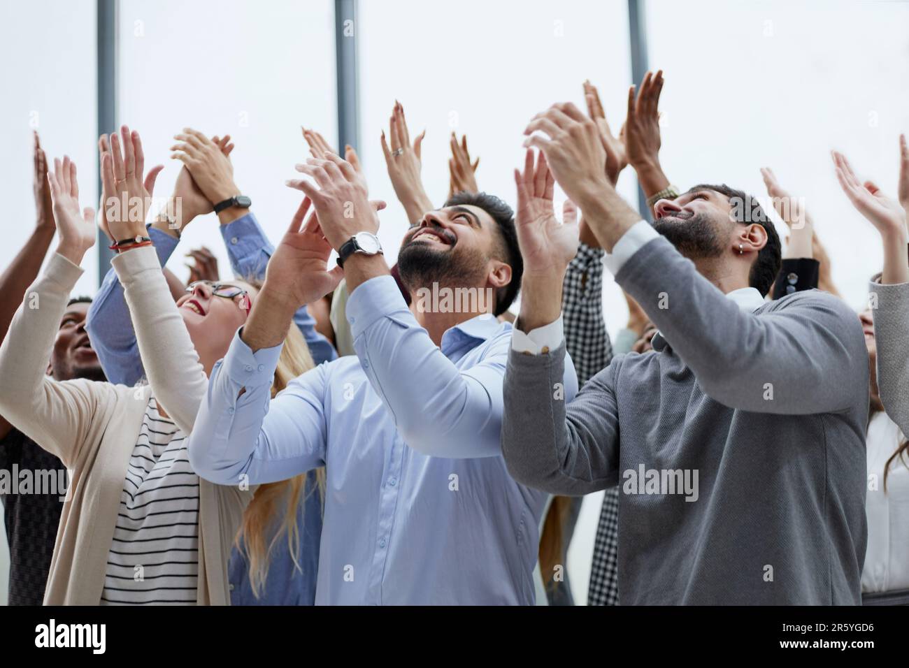 large group of diverse young people looking up hopefully Stock Photo ...