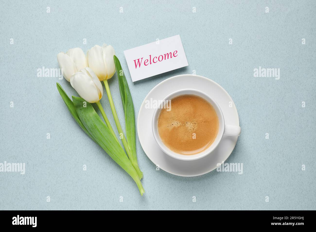 Welcome card, beautiful white tulips and cup of aromatic coffee on pale ...