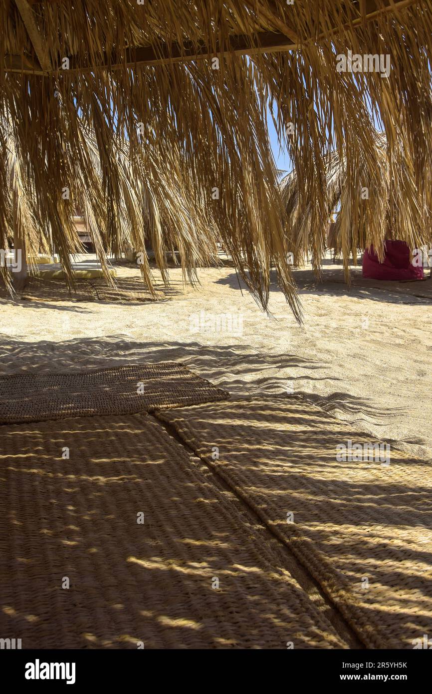 Beach umbrella made from dry palm leaves. Summer travel and vacation ...