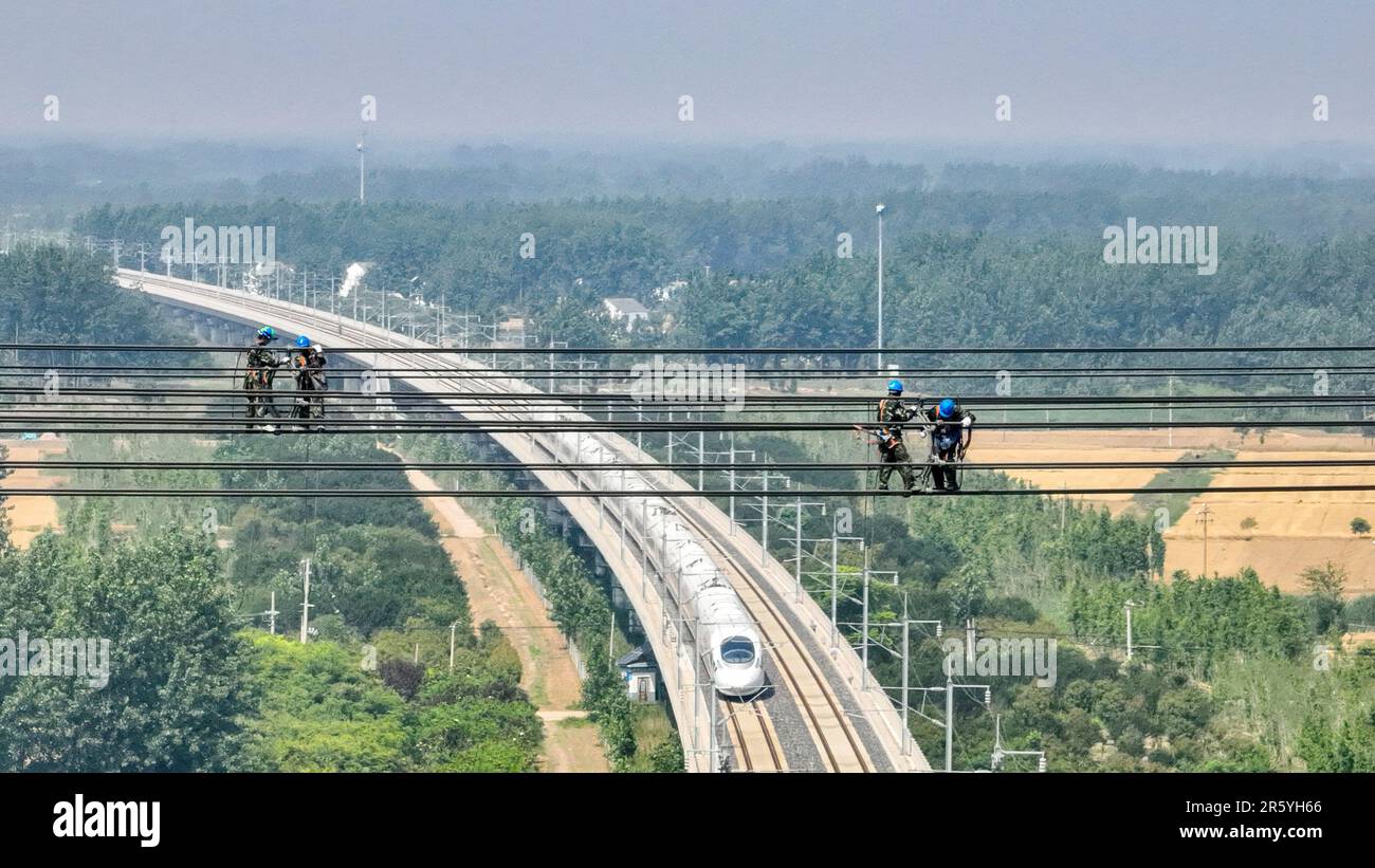 YANCHENG, CHINA 0 JUNE 6, 2023 - Maintenance personnel at a À800 kV ...