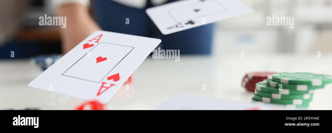 Hand is tossing cards with aces and dice Stock Photo - Alamy