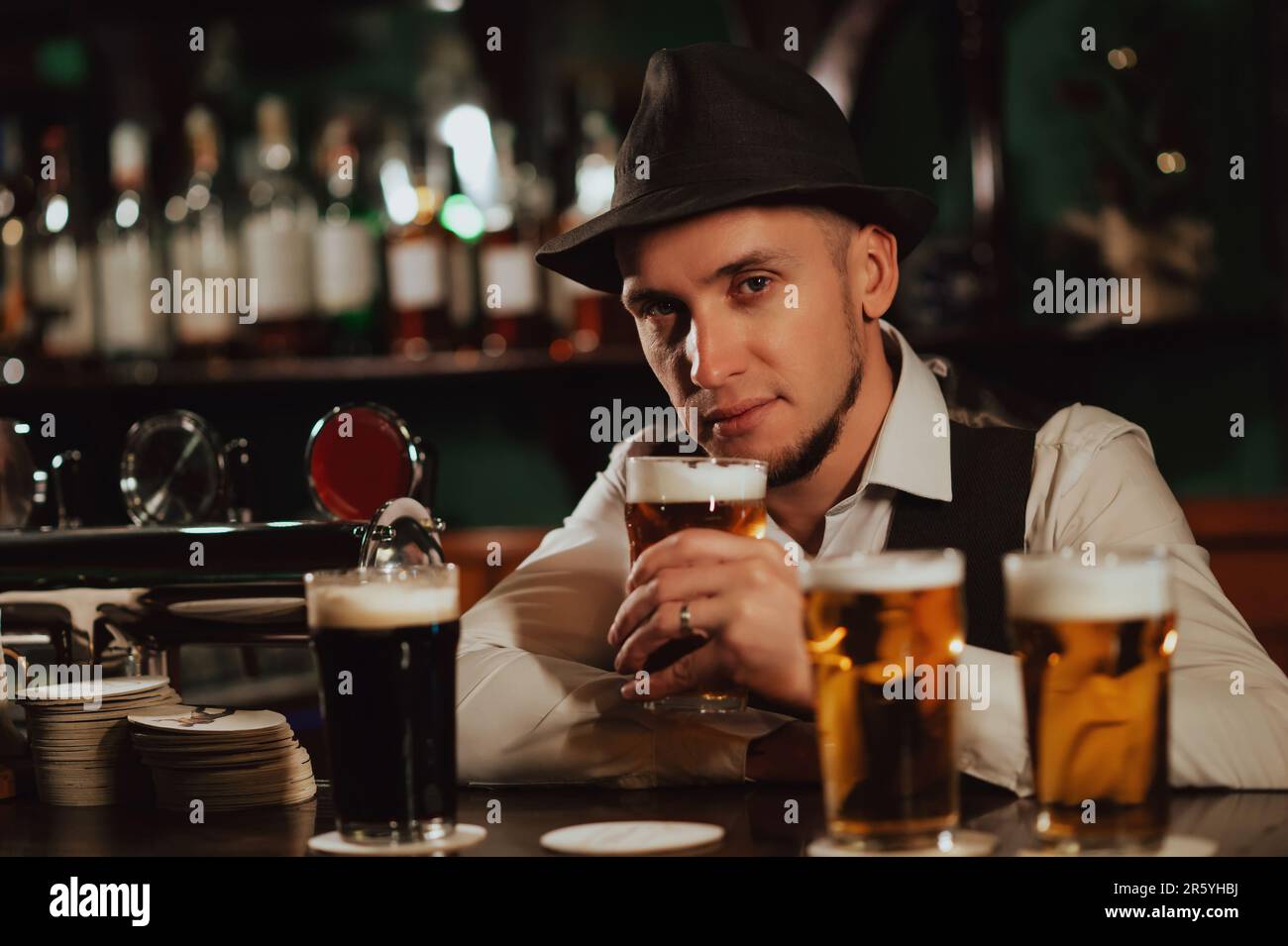 bartender at bar counter tasting various varieties of craft beer in pub ...
