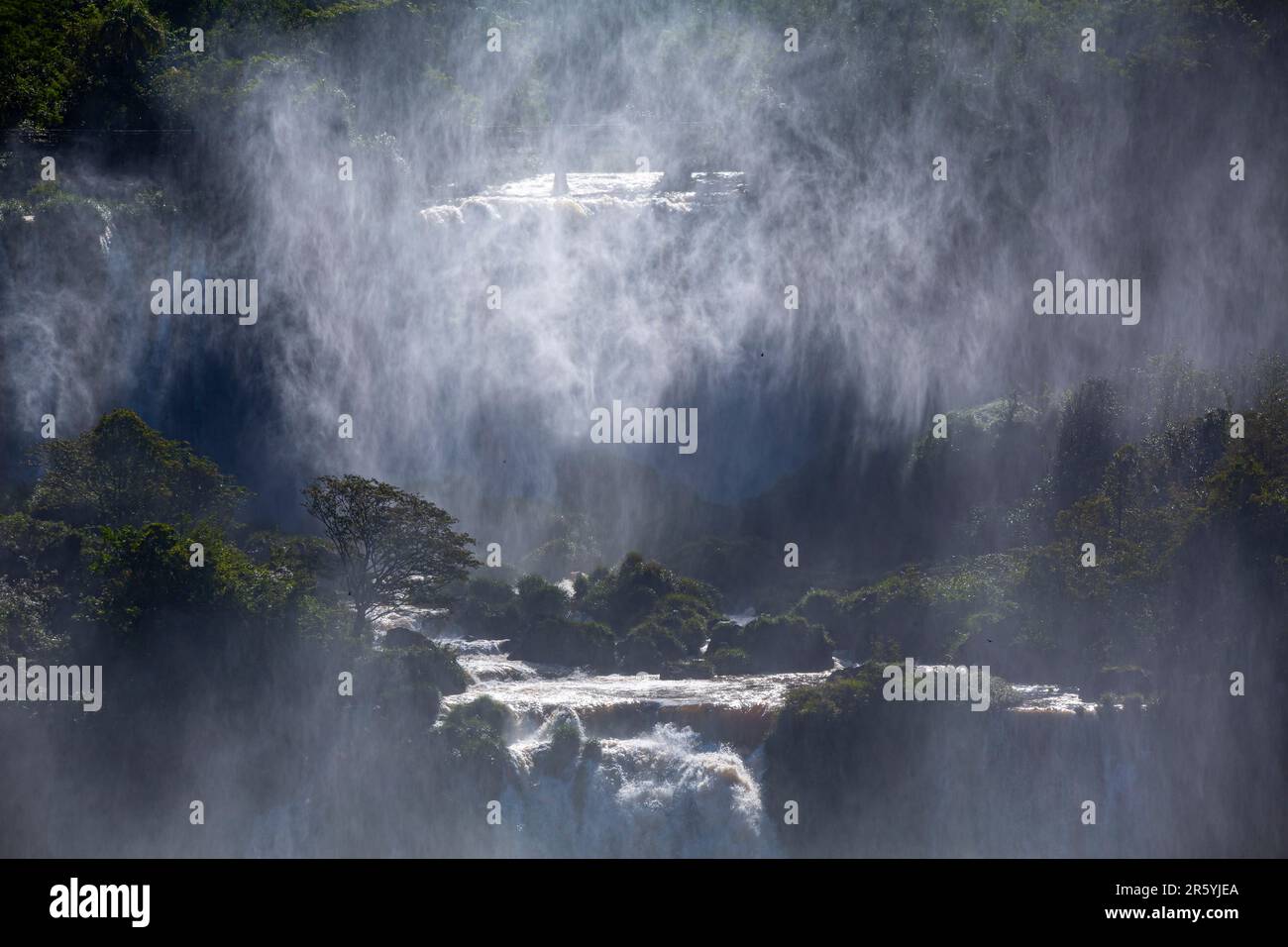 Mystical view to waterfall cascades with a wall of spray and sunlight ...
