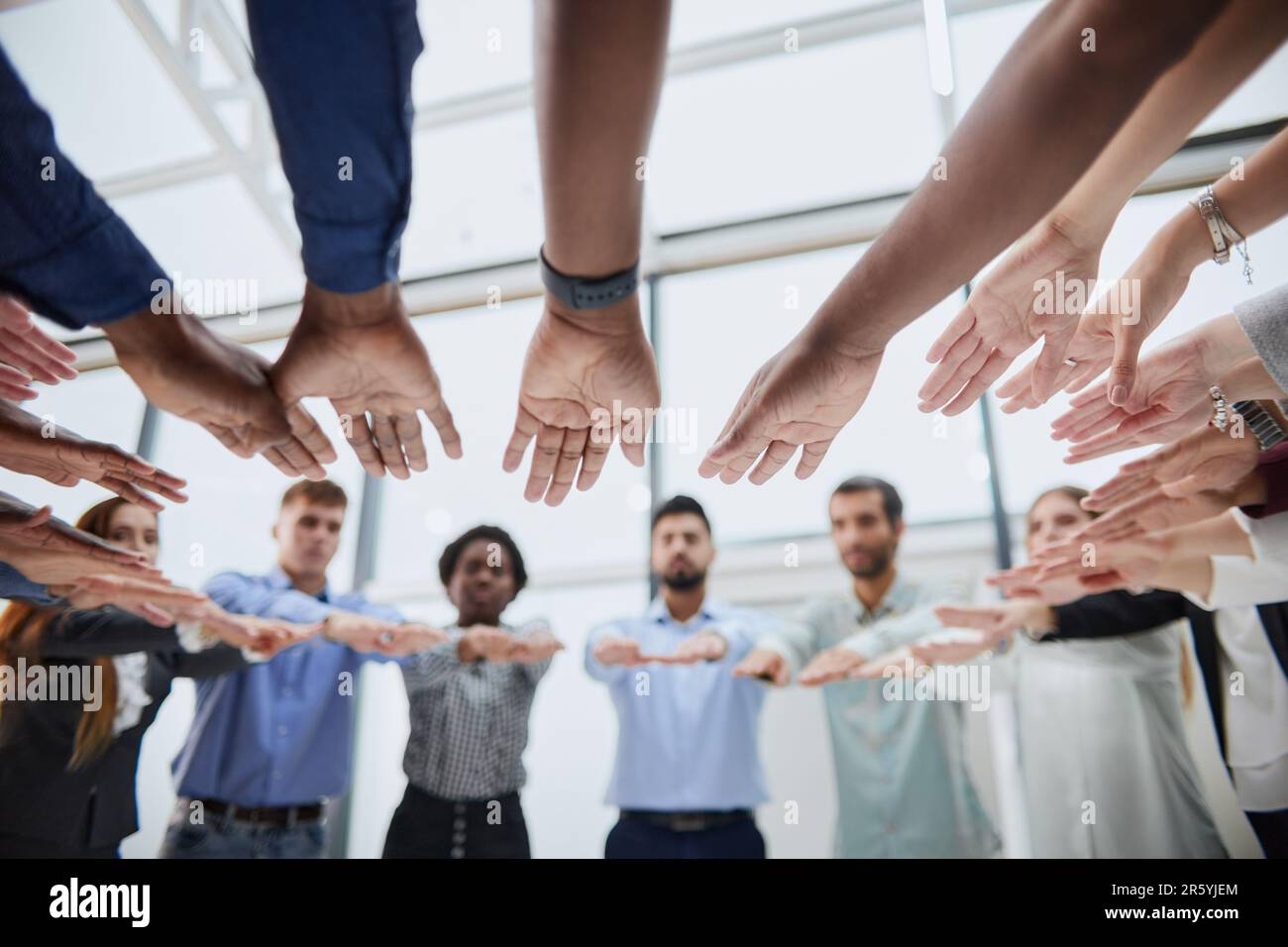 a group of young people stretched out their hands towards Stock Photo ...