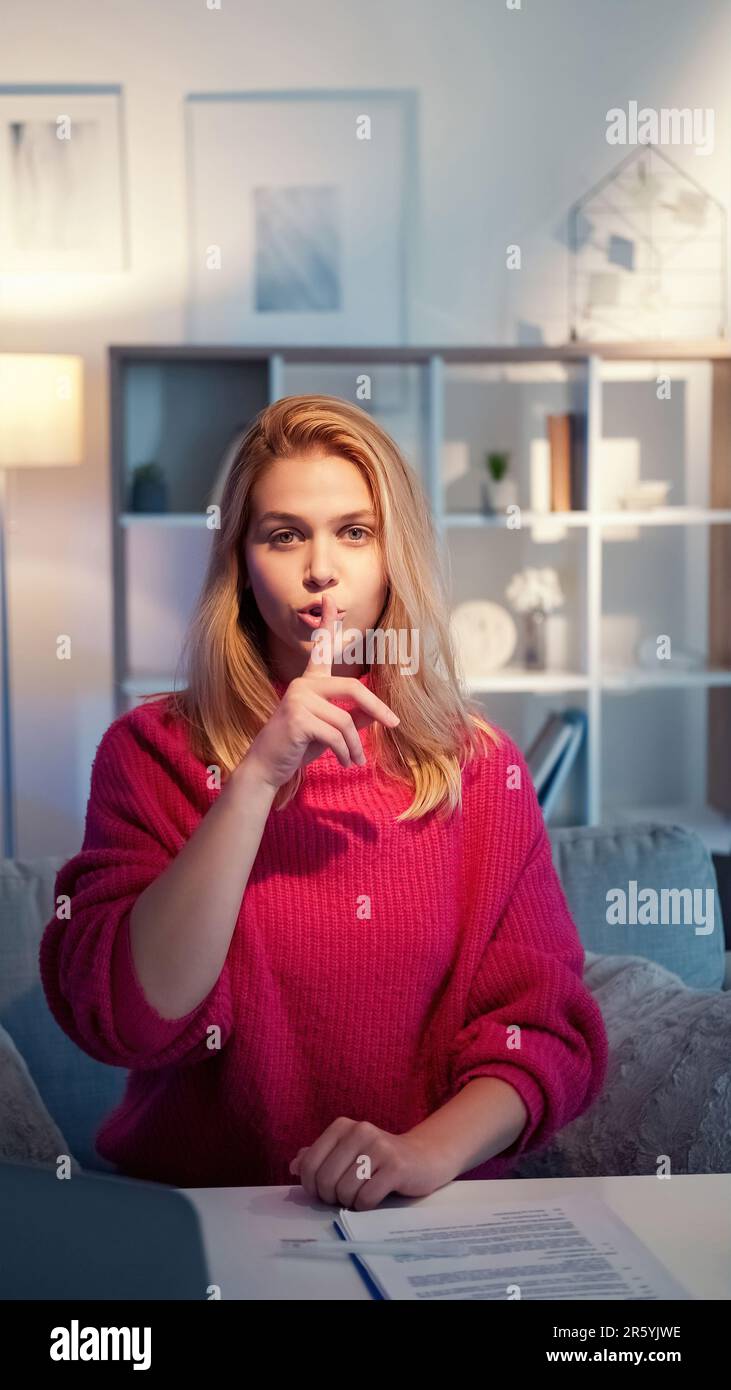 Keep quiet silent woman hand gesture conspirator Stock Photo - Alamy