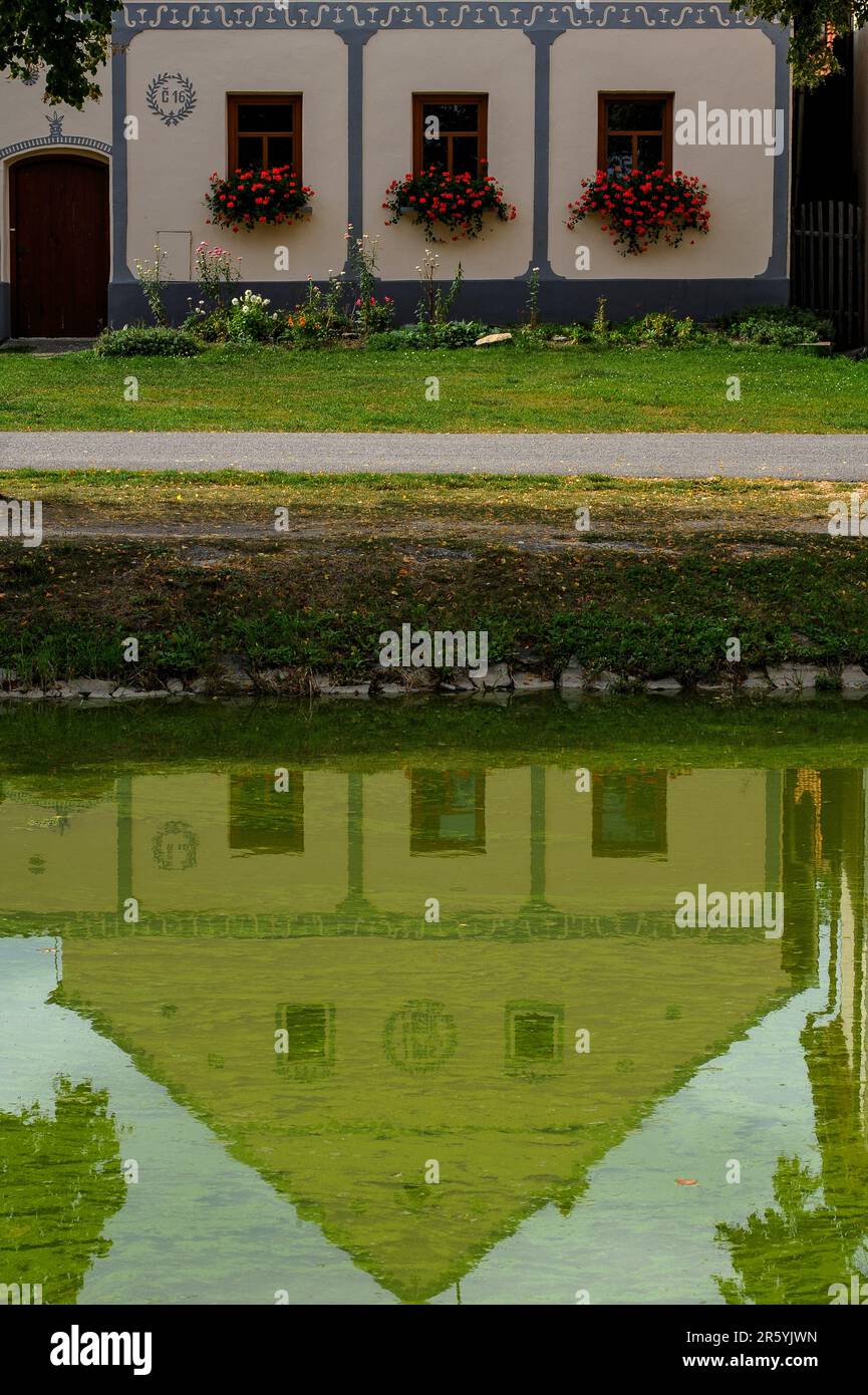Window boxes and pointed gable of farmstead in Holašovice, South ...