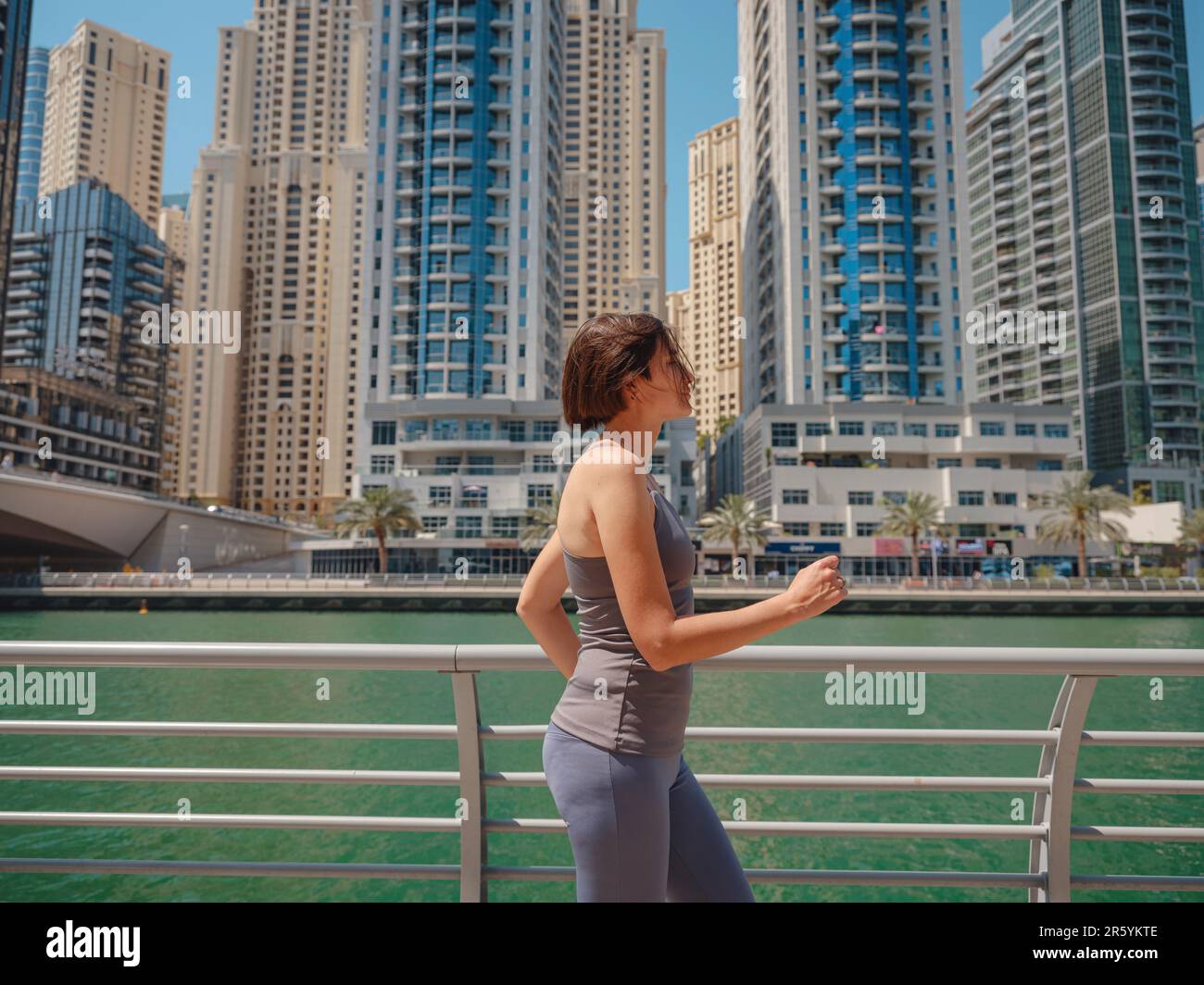 City Running - asian woman runner , Dubai marina urban scene in ...