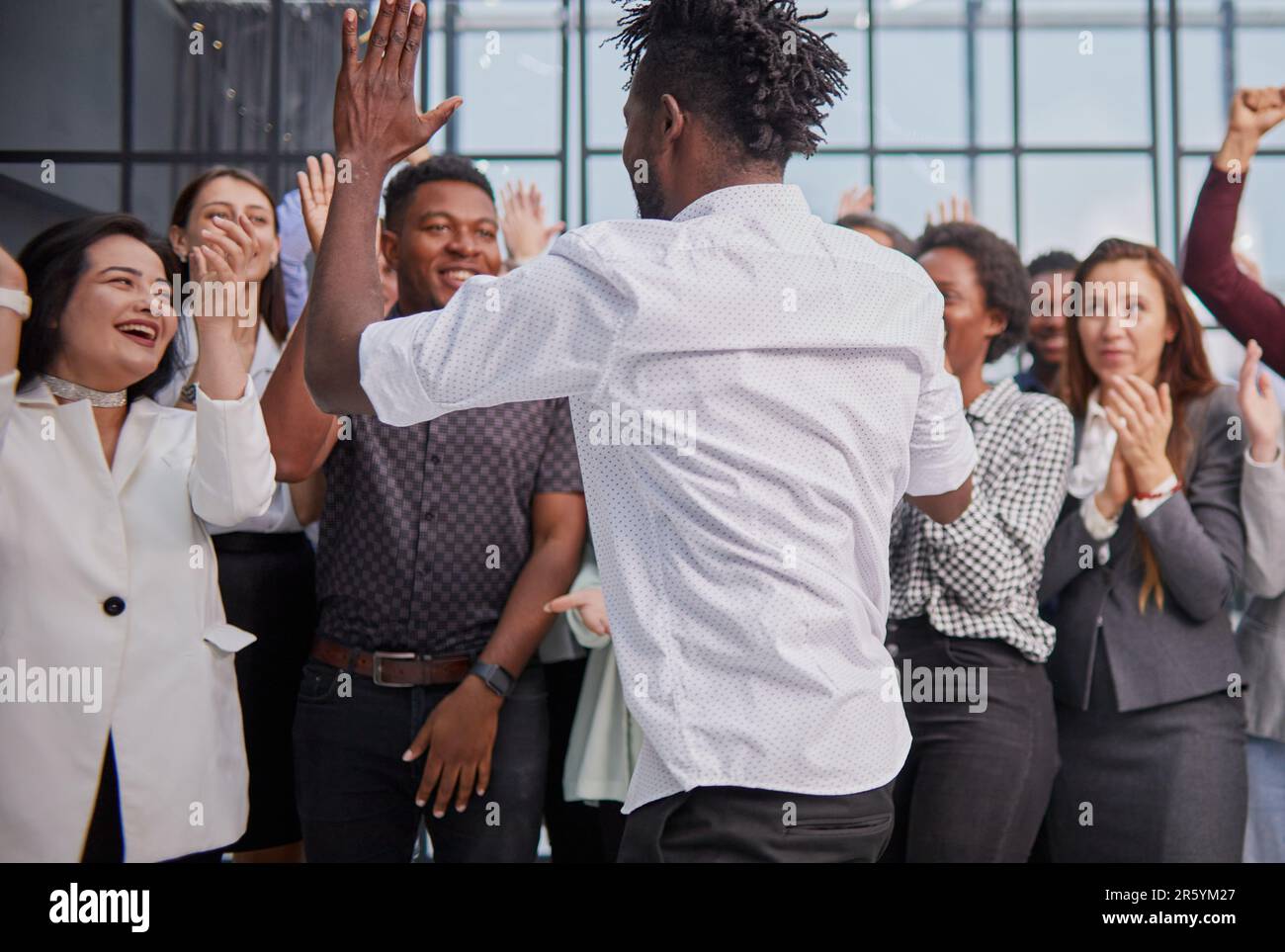 Excited multinational employees celebrating team victory giving high ...