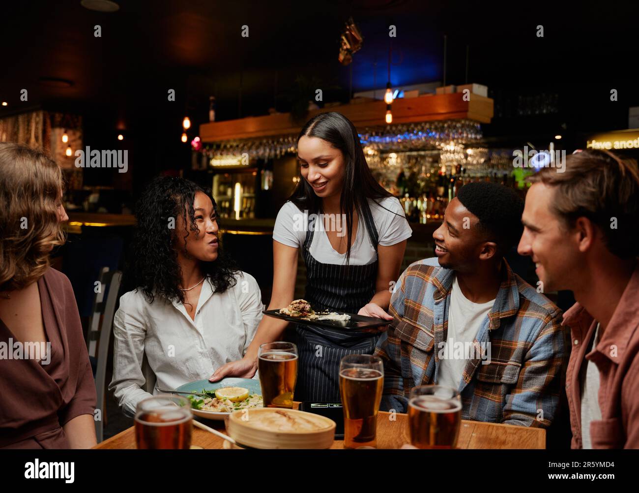 Happy young multiracial group of friends in casual clothing receiving ...