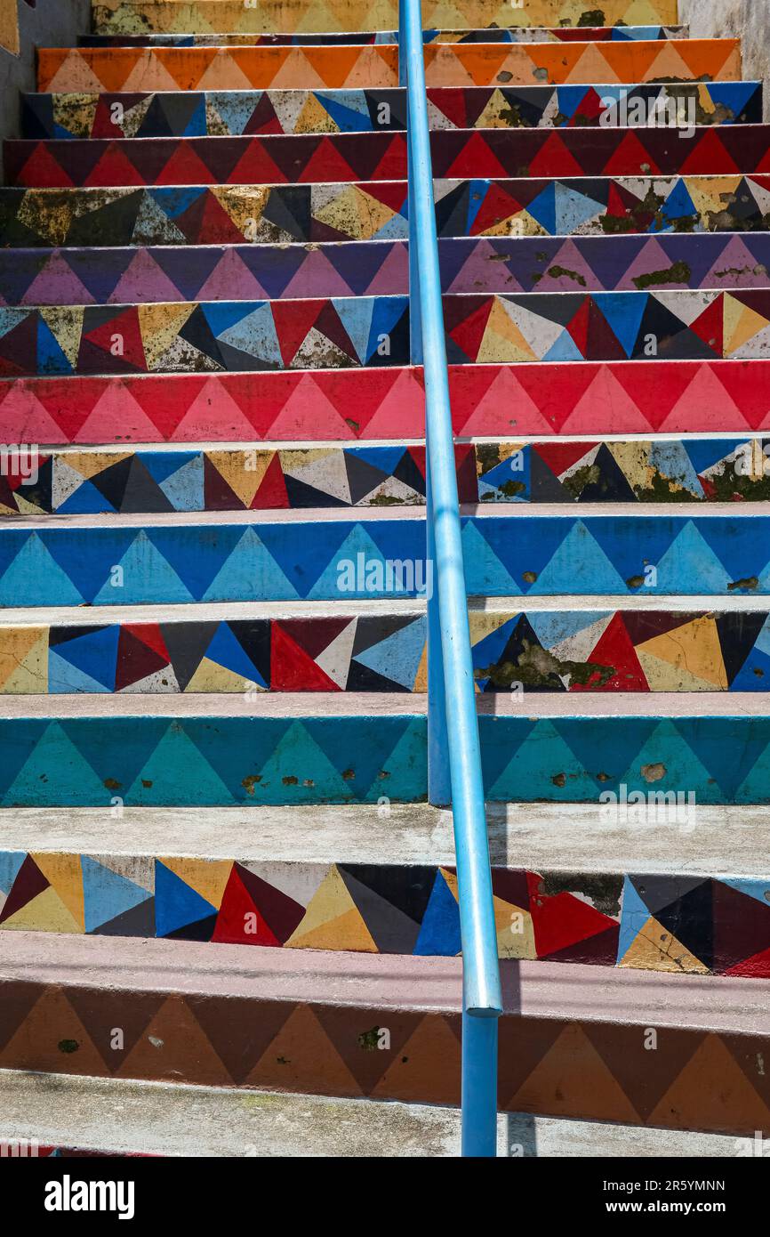 Colorful tiled steps of a stairway with blue handrail in historical ...