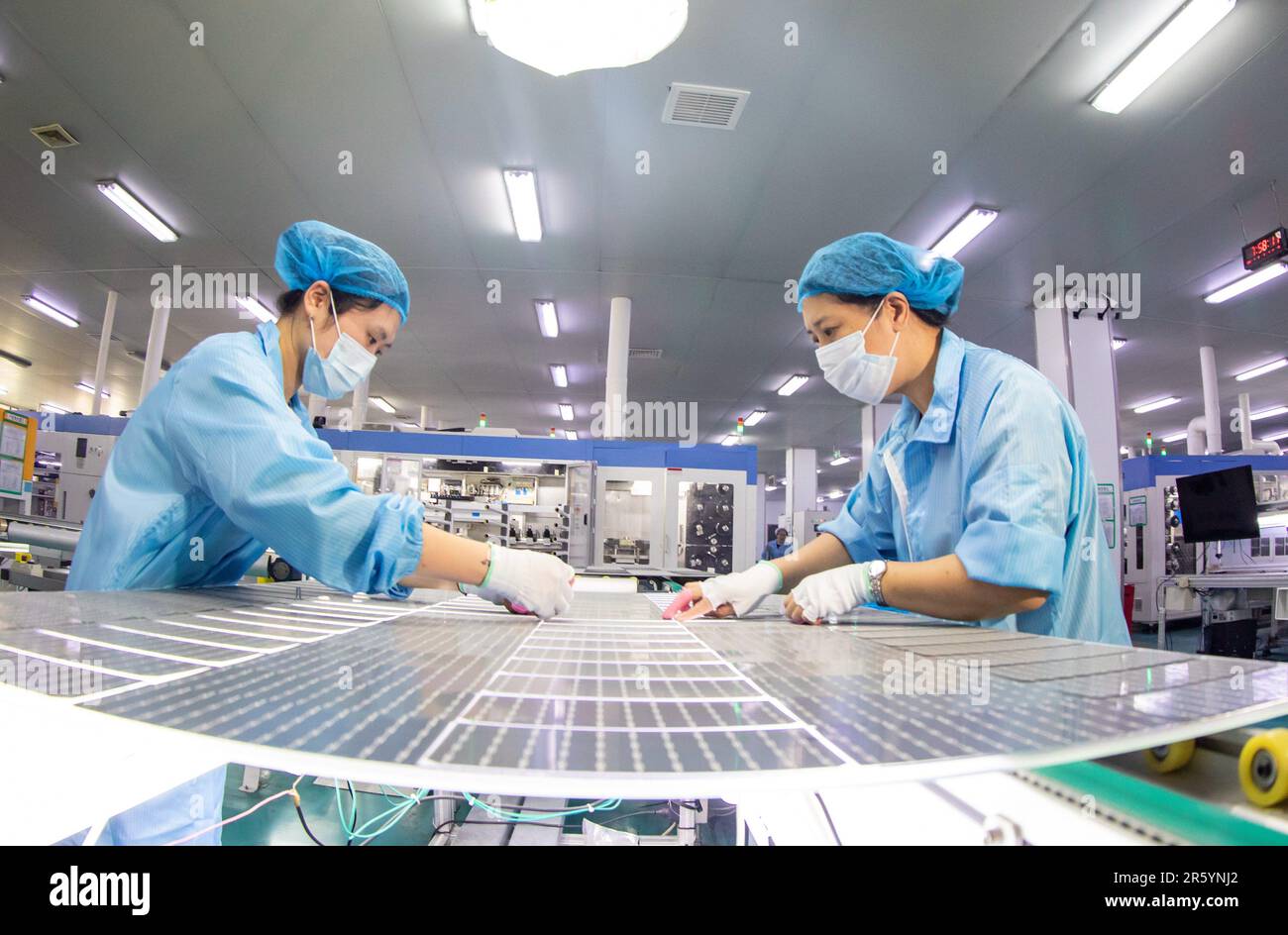 HAIAN, CHINA - JUNE 6, 2023 - Workers produce solar photovoltaic ...