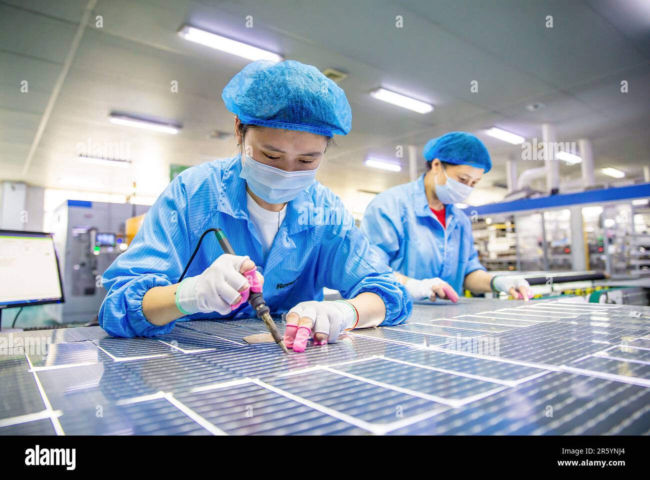 HAIAN, CHINA - JUNE 6, 2023 - Workers produce solar photovoltaic ...