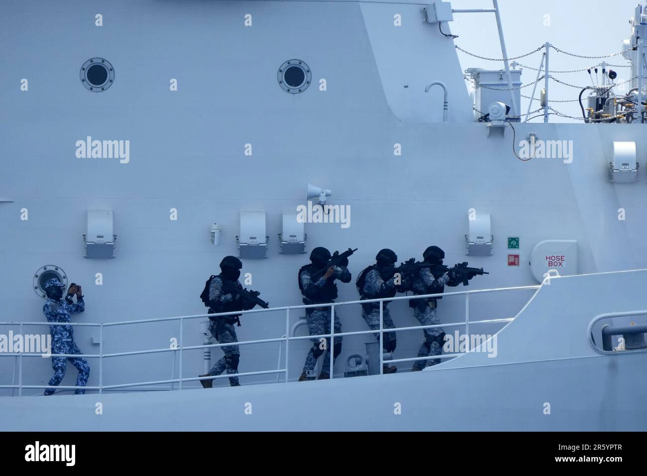 A Philippine Coast Guard personnel, left, participate in a drill on ...