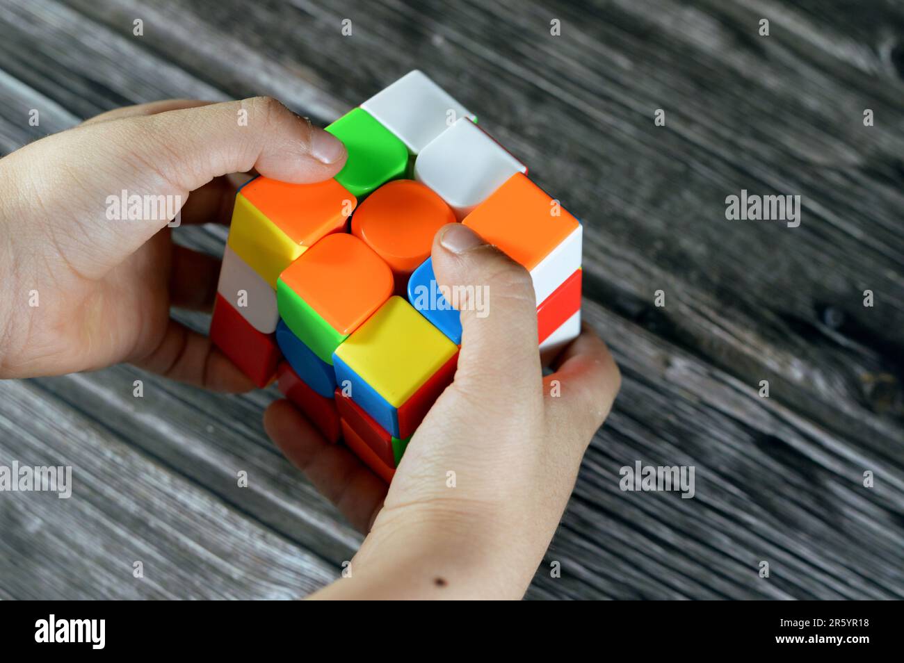 Cairo, Egypt, May 26 2023: Solving the Rubik's Cube by a child, combination puzzle, speed magic ...