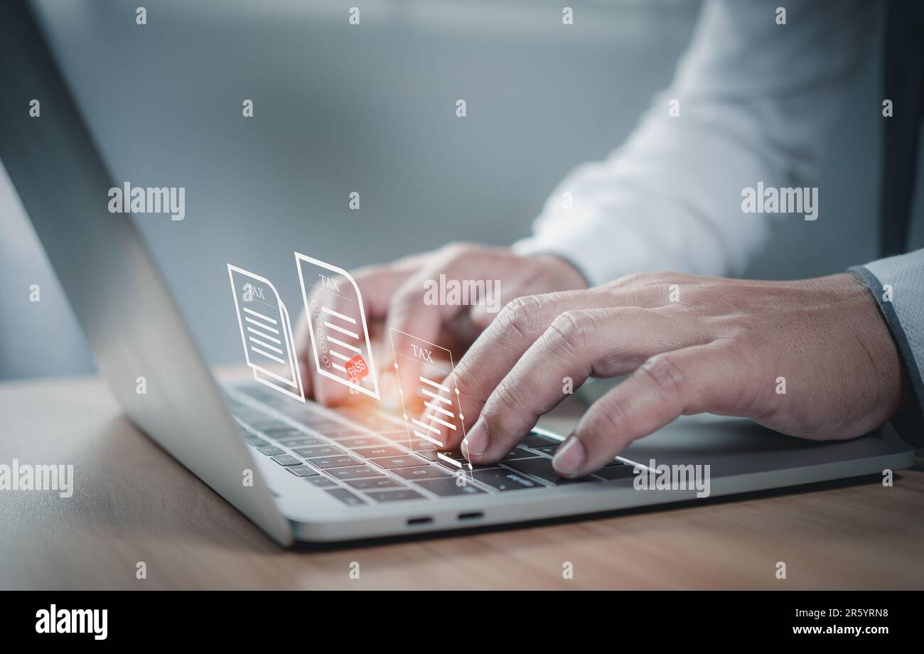 Businessman using a computer to complete Individual income tax return ...