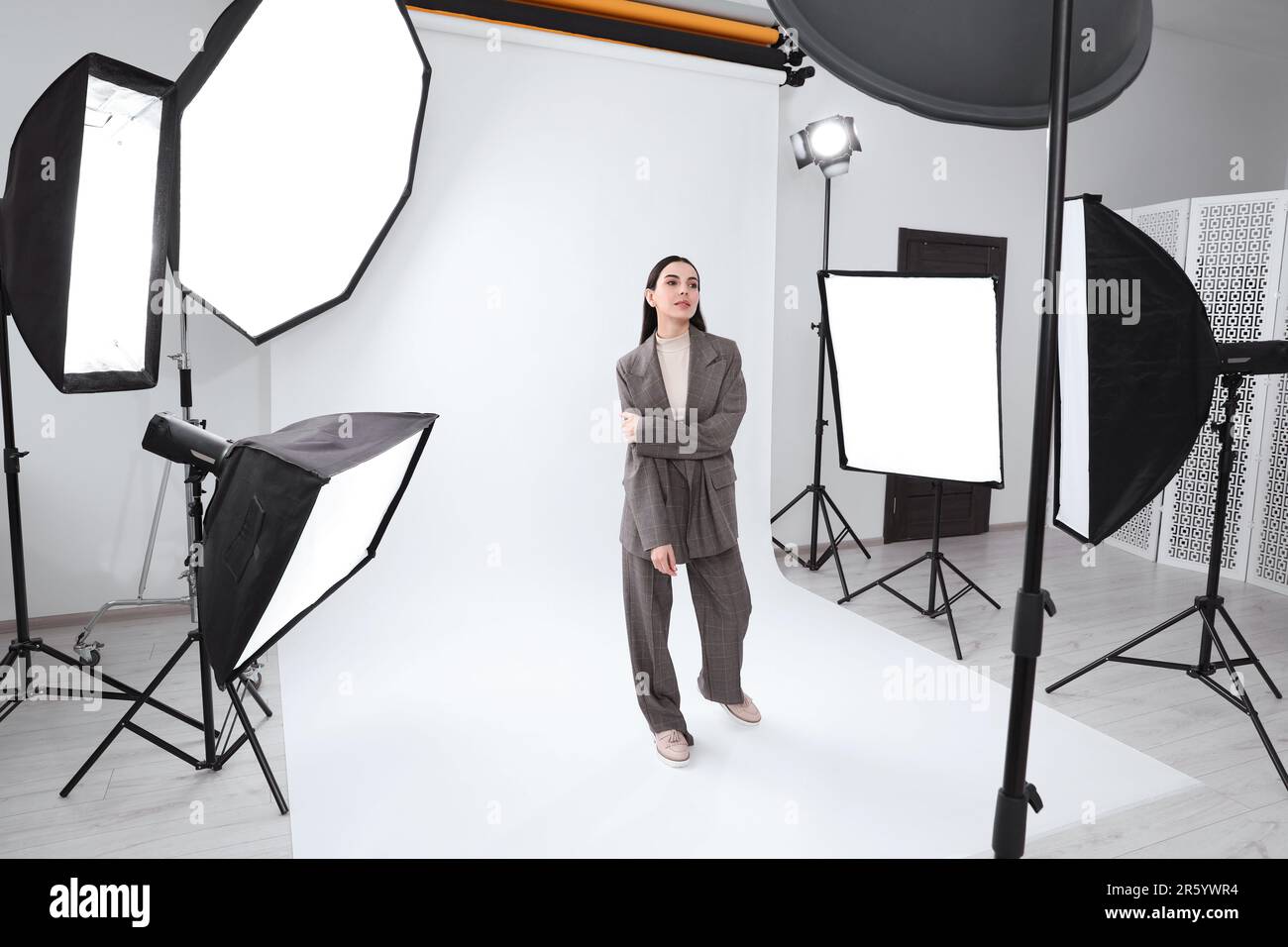 Beautiful young model posing in modern studio. Professional photo ...