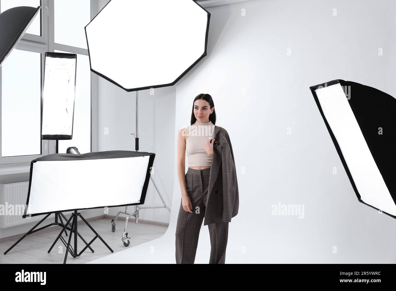 Beautiful young model posing in modern studio. Professional photo ...