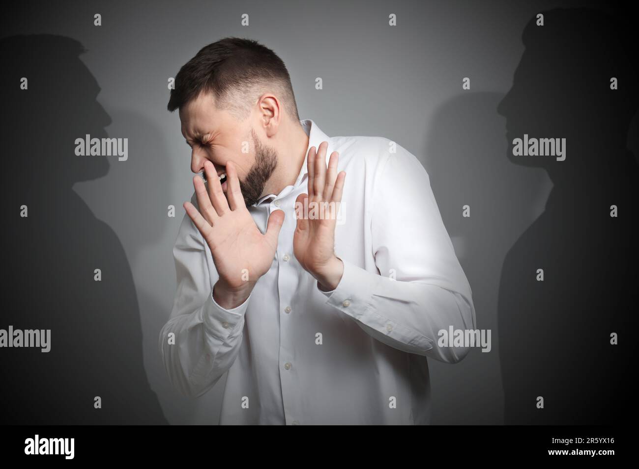 Suffering from hallucination. Scared man having delusion as shadows of ...