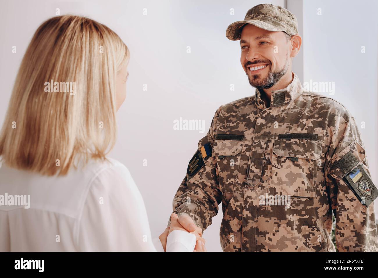 Psychologist shaking hands with military officer in office Stock Photo ...
