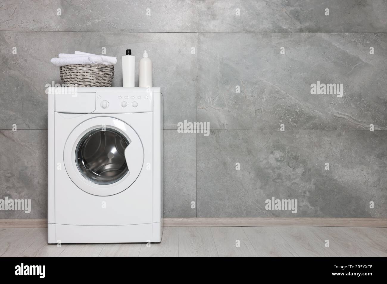 Empty laundry room with modern washing machine, space for text ...