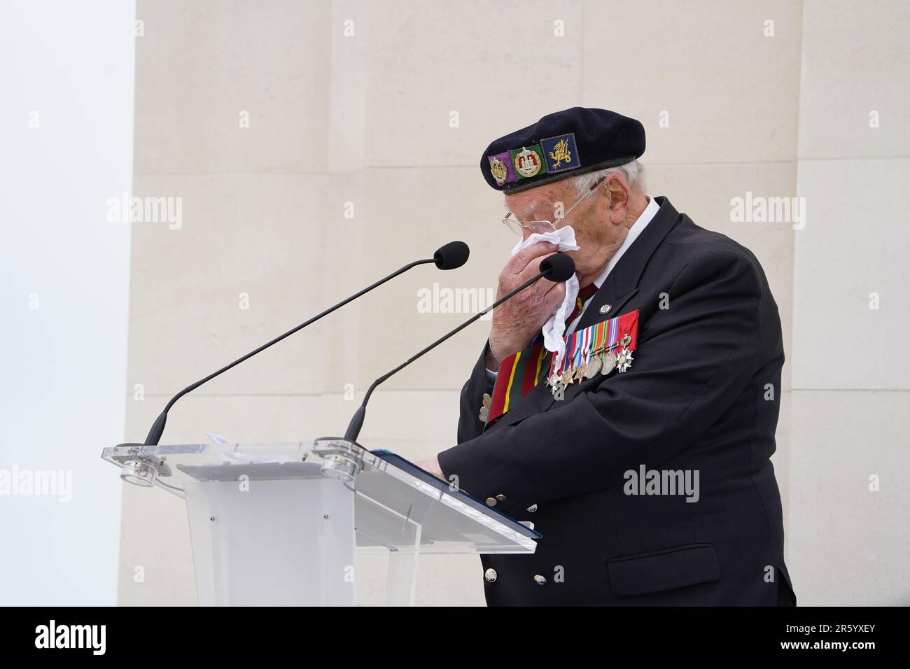 D-Day veteran Ken Hay wipes away tears as he speaks during the Royal ...