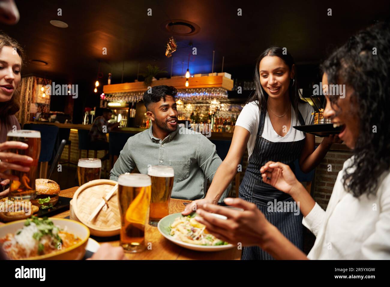 Young multiracial group of friends in casual clothing smiling while ...