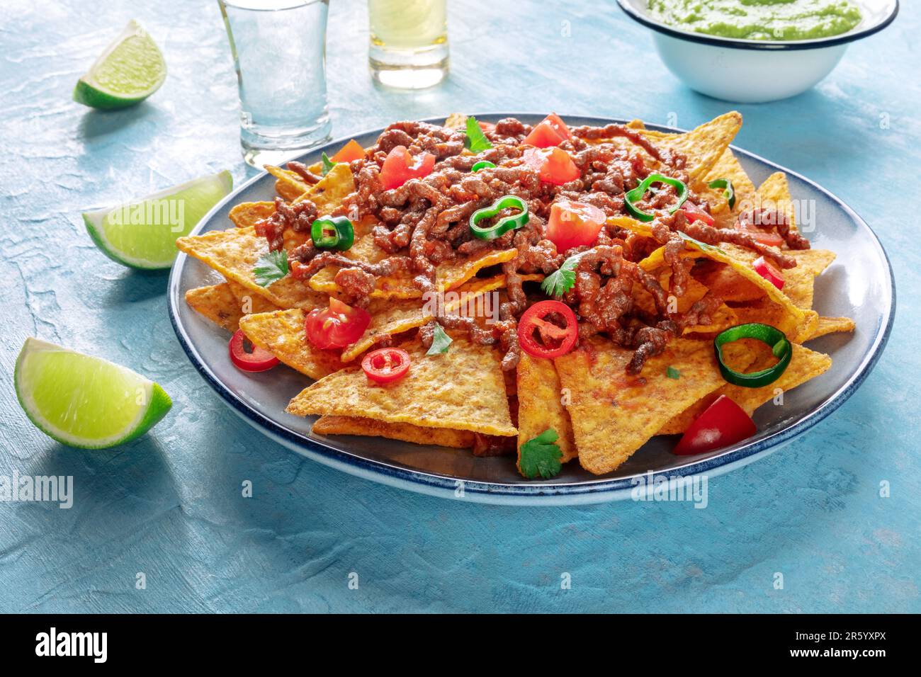 Nachos, Mexican food, tortilla chips with beef and fresh vegetables ...