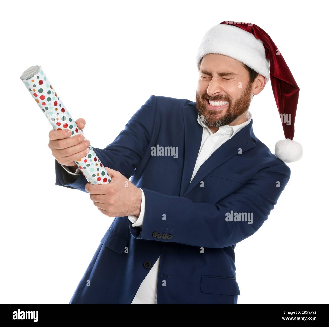 Emotional man blowing up party popper on white background Stock Photo ...