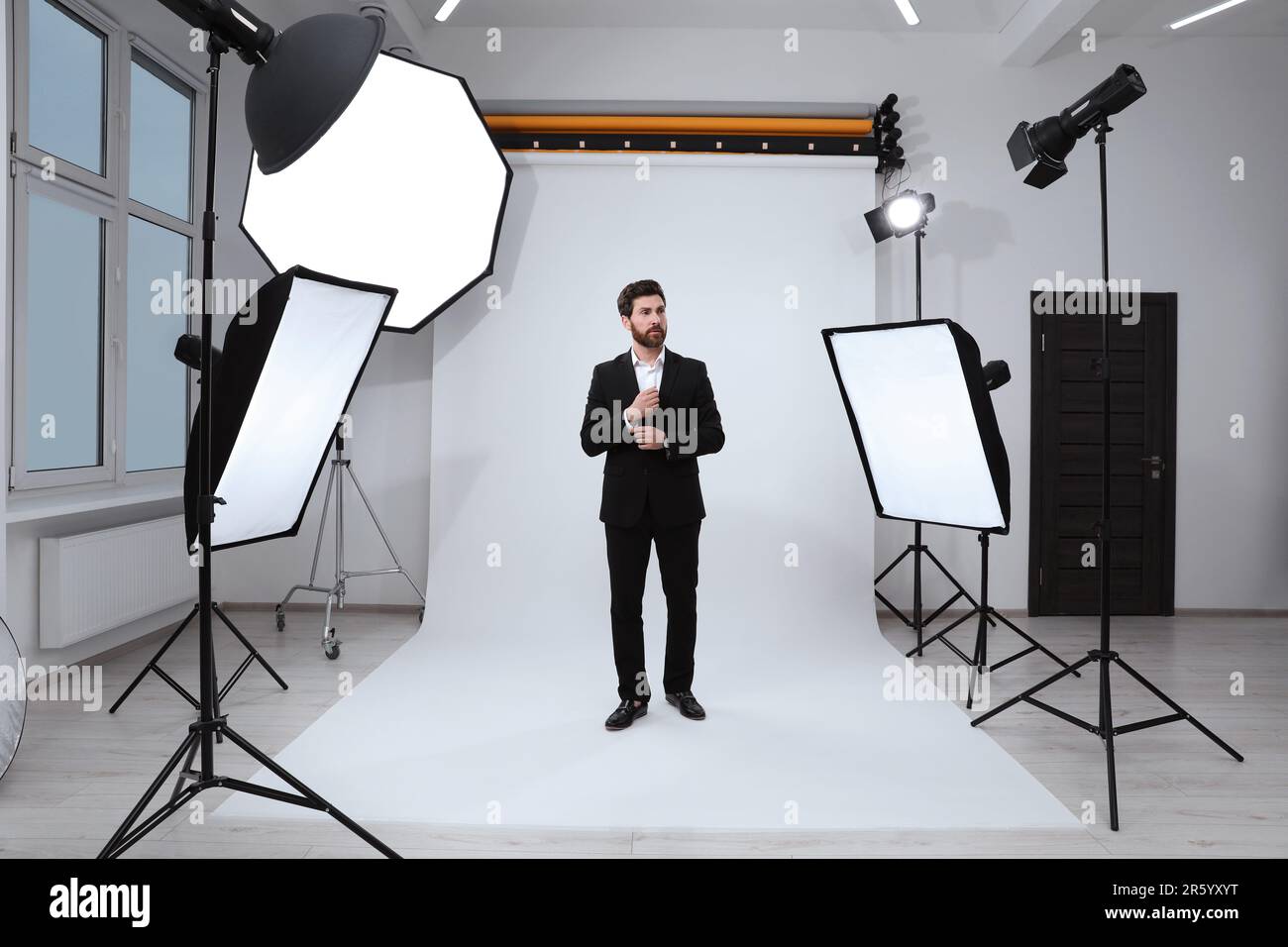 Handsome model posing in modern studio. Professional photo session ...