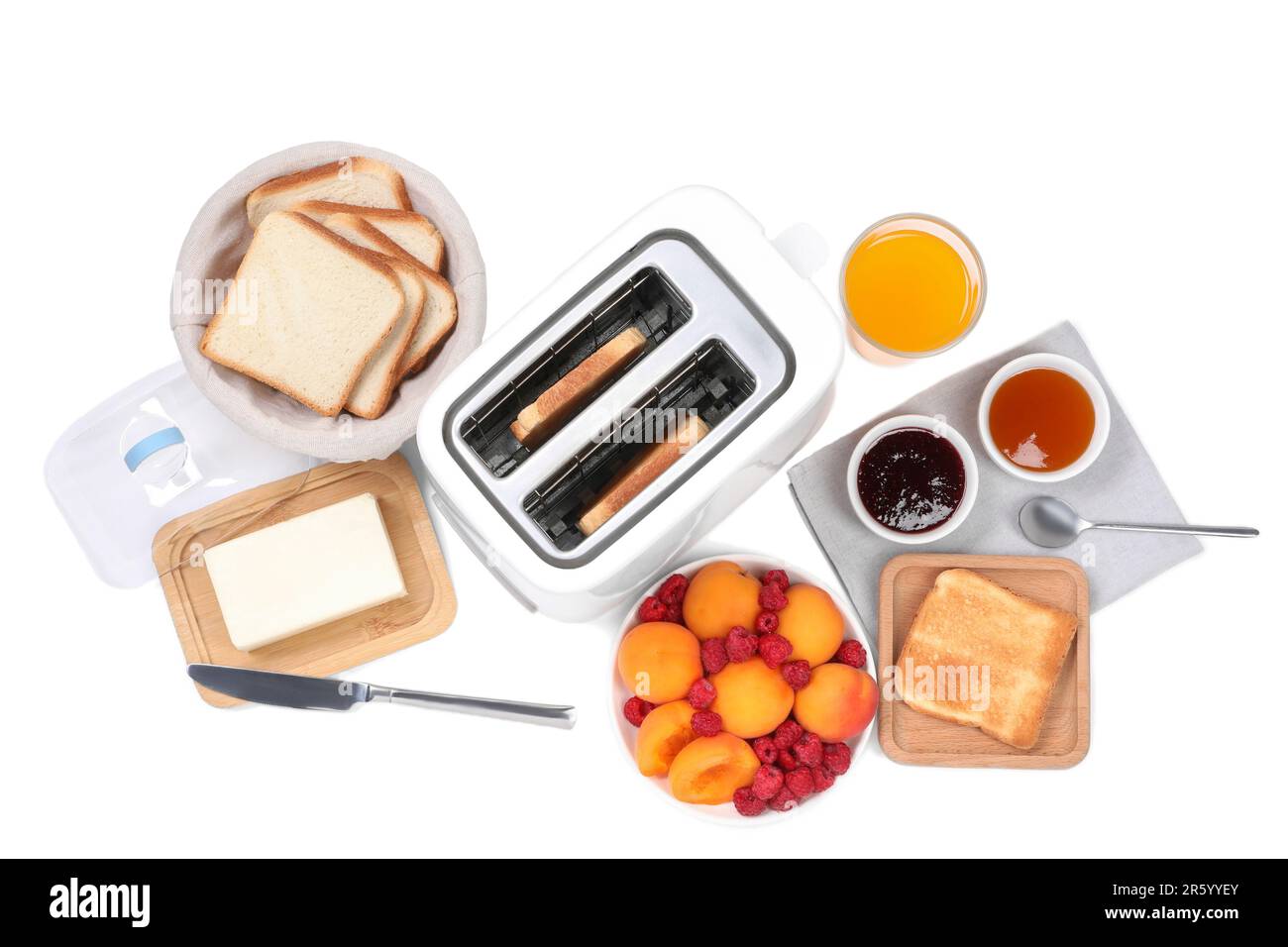 Modern toaster, bread, butter, fresh fruits and jams on white background, top view Stock Photo ...