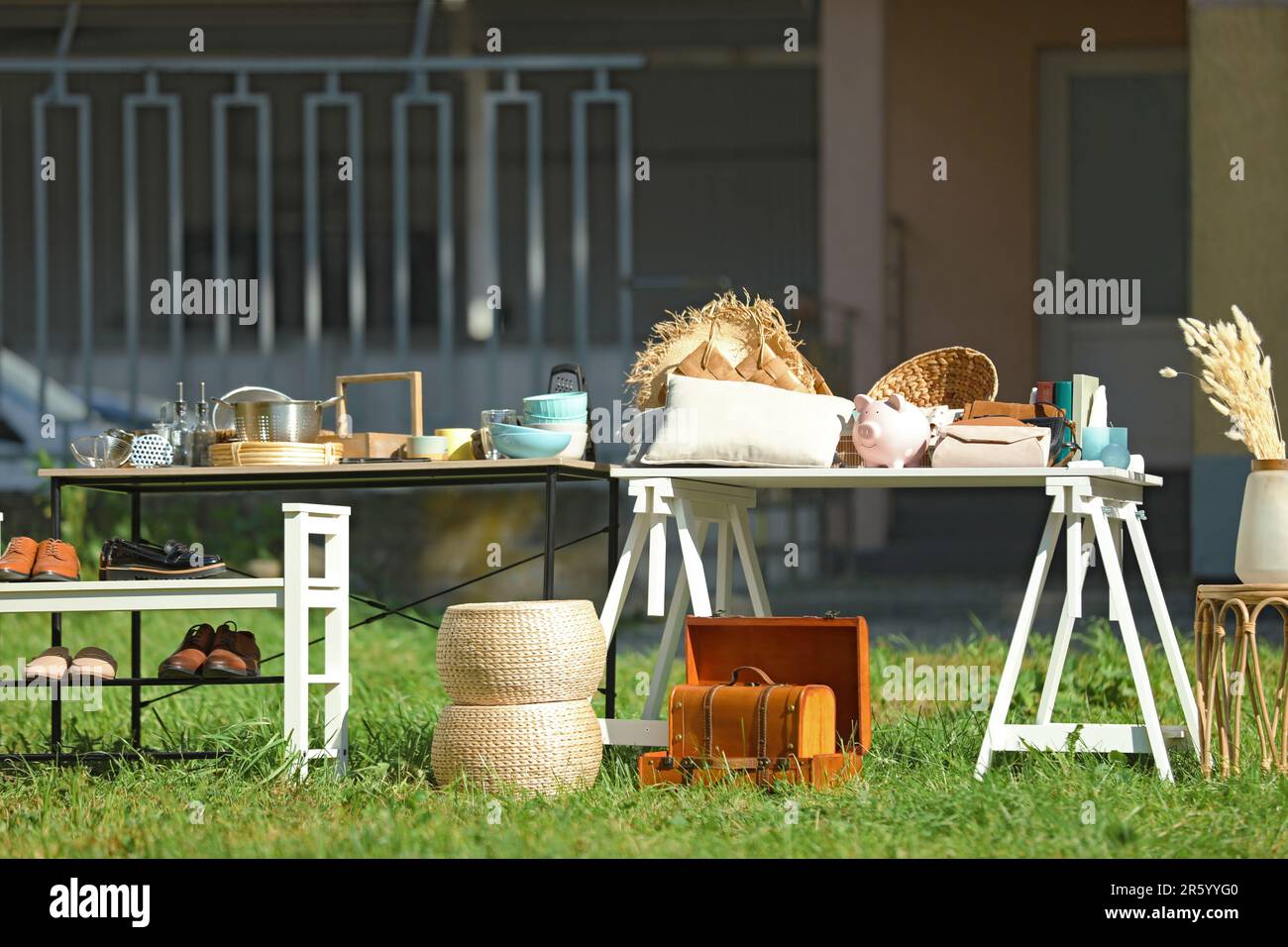 Small tables with many different items on garage sale in yard Stock ...