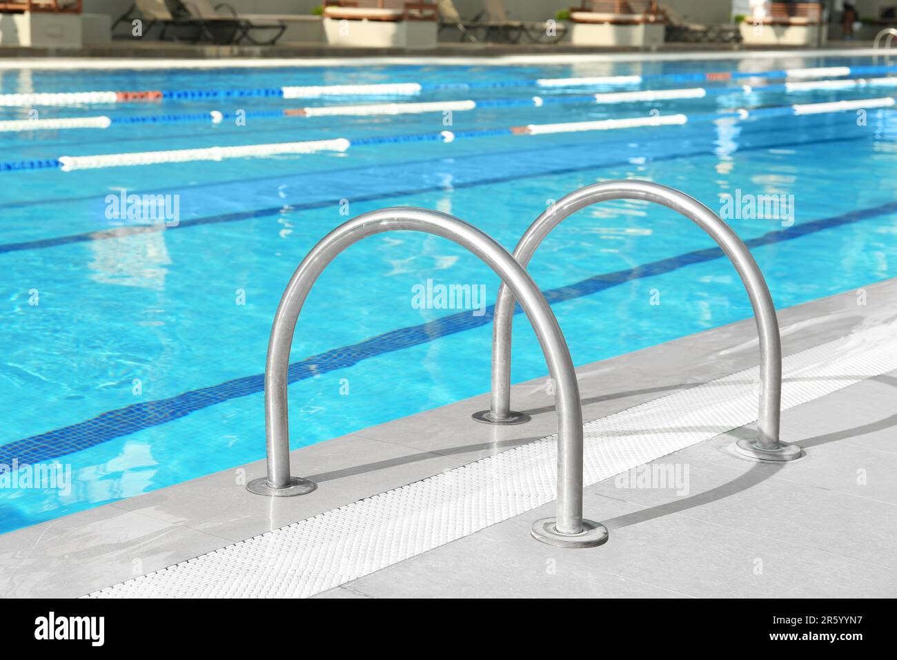 Ladder with handrails in outdoor swimming pool Stock Photo - Alamy