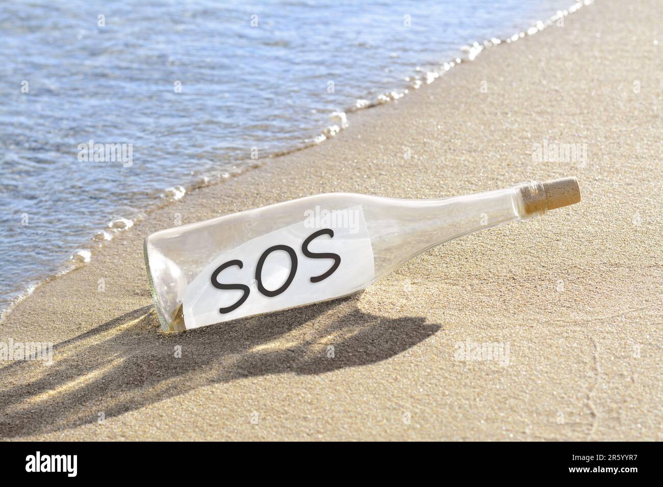 Sos message written on sand hi-res stock photography and images - Alamy