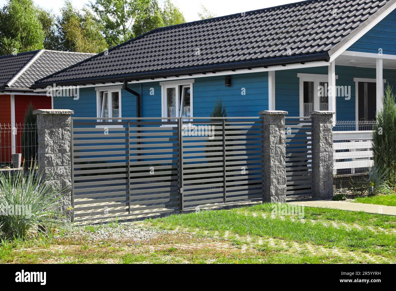 Metal gates near beautiful buildings on sunny day Stock Photo - Alamy